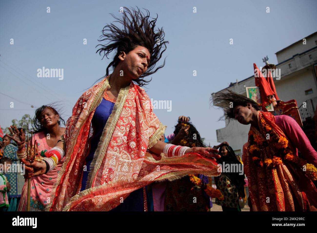 A Sikh devotee wearing a huge turban waits to offer prayers at an ...