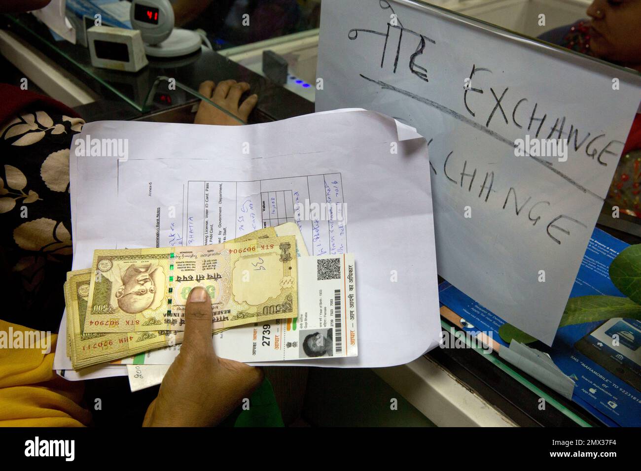 An Indian queues up to exchange Rupees five hundred denomination notes ...