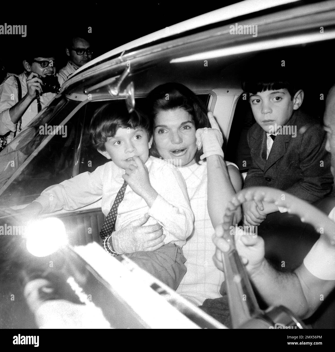 Jacqueline Kennedy holds her nephew, Anthony Radziwill, on her lap as ...