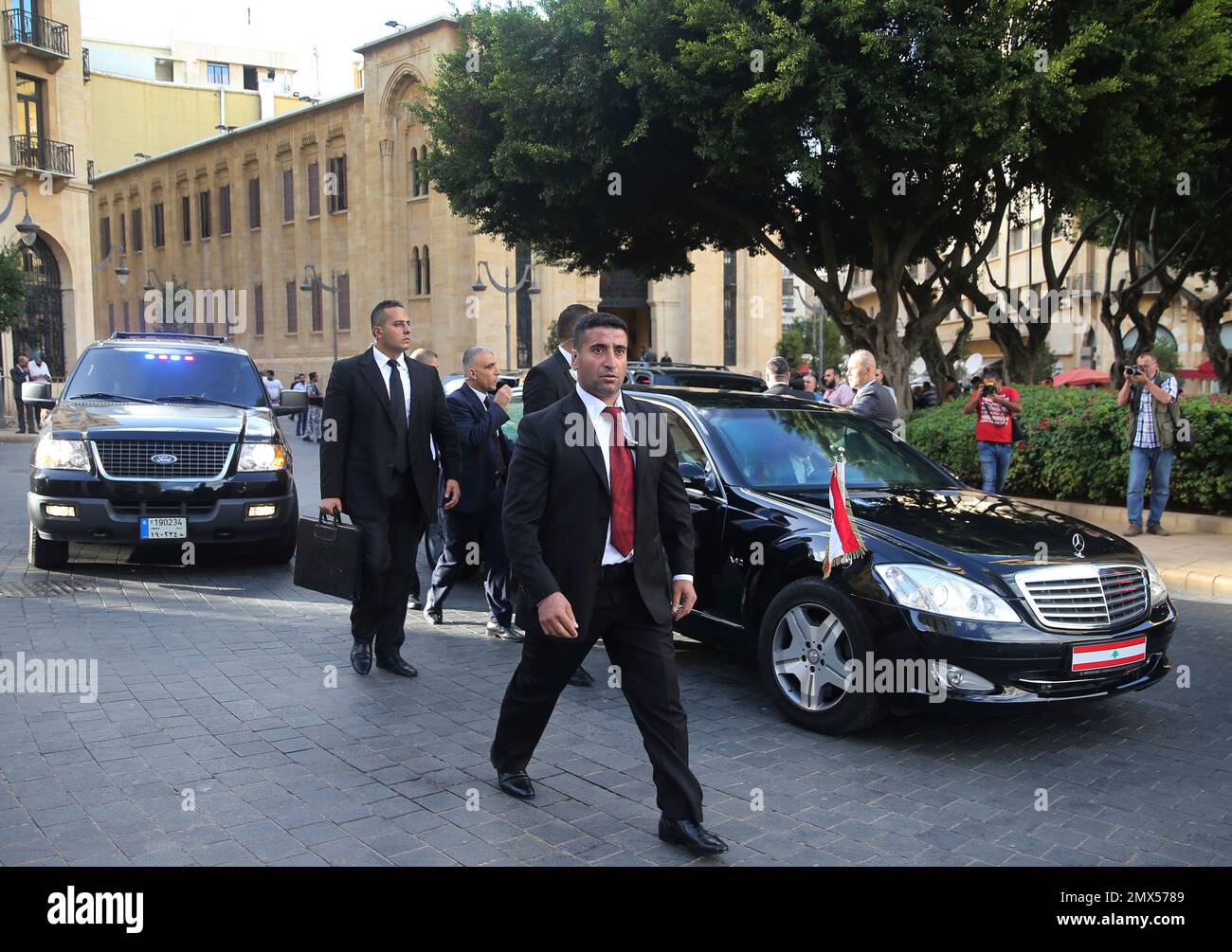 Lebanese presidential guard officers escort a car carrying the newly ...