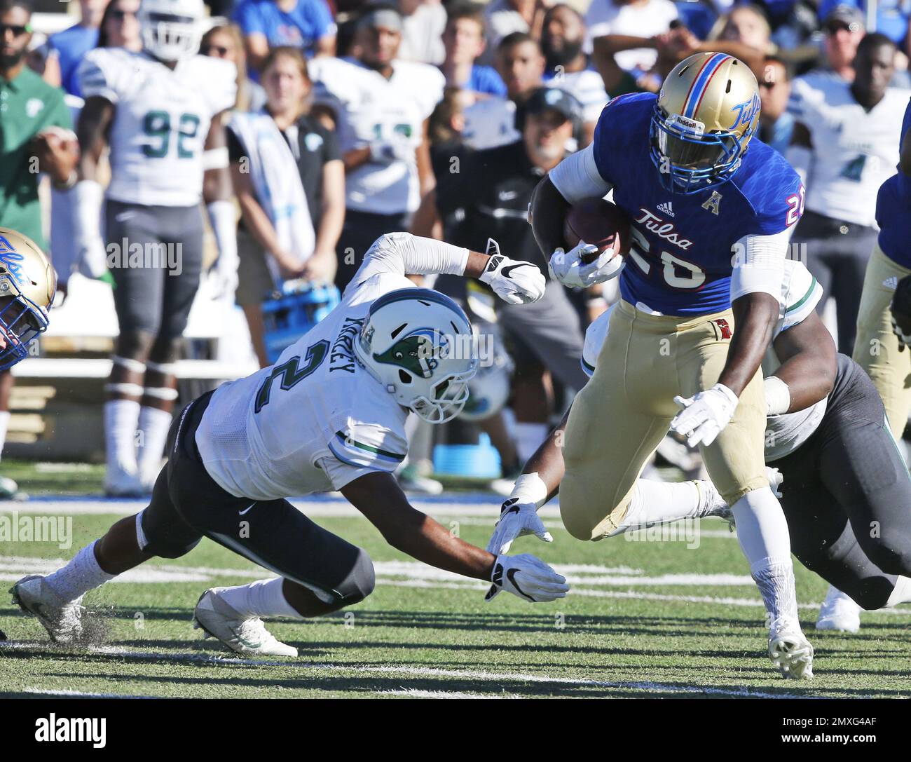 Tulane's Nico Marley (2) moves in to tackle Tulsa running back James ...