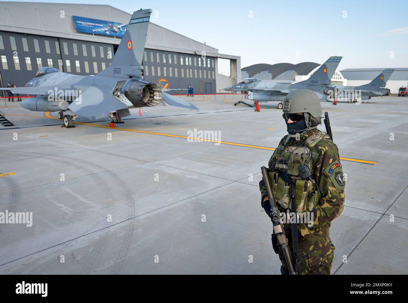 A Romanian soldier secures the perimeter around Romanian Air Force F16 ...
