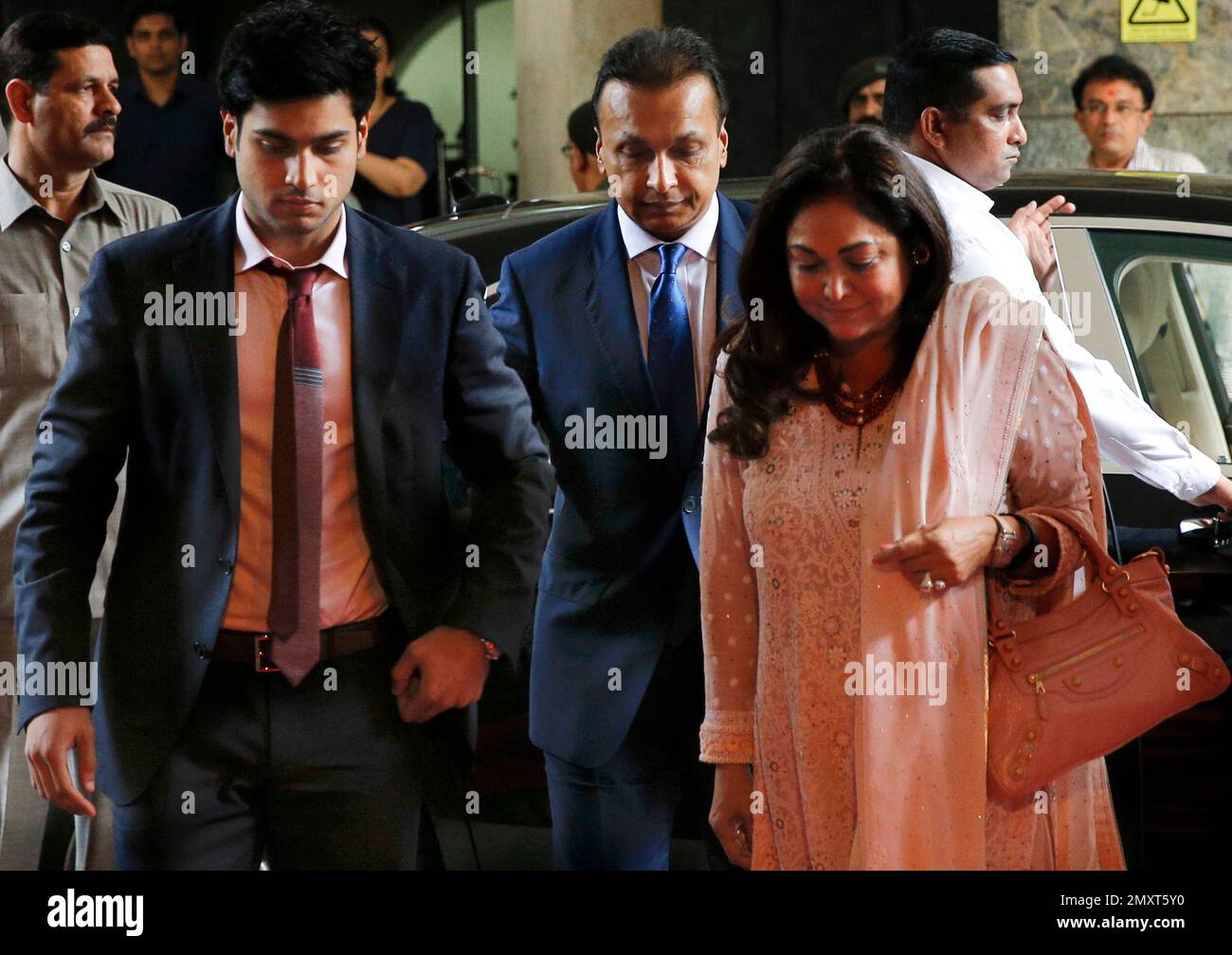 Chairman of Reliance Group Anil Ambani, center, arrives with his son ...