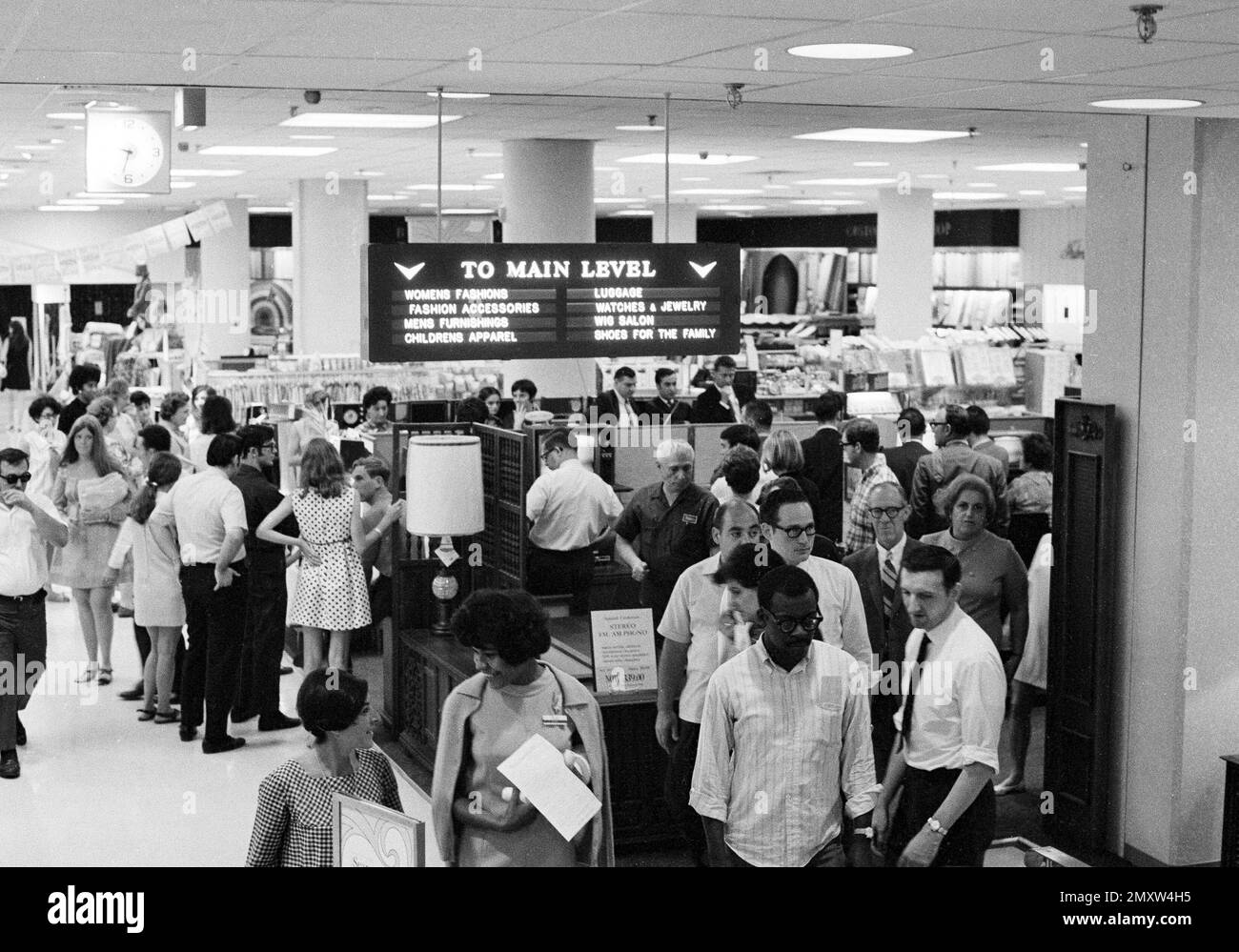 People watch the Apollo 11 Saturn V rocket launch on TV's (not shown ...