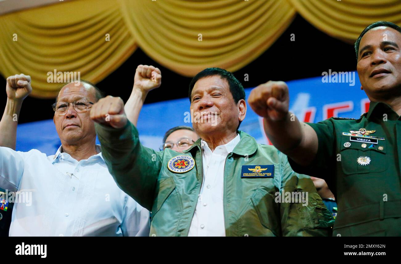 Philippine President Rodrigo Duterte, center, poses with a fist bump ...