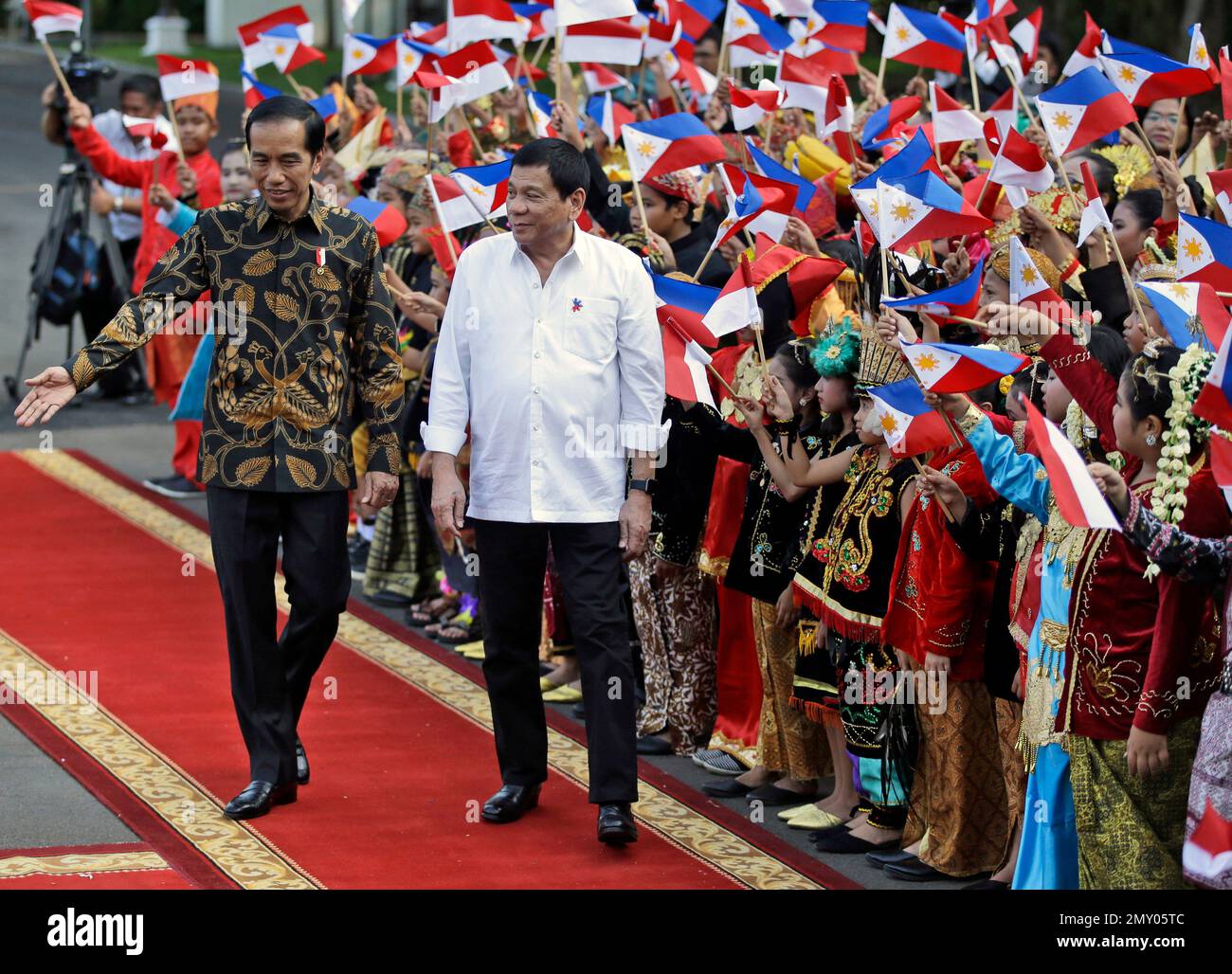 Philippine President Rodrigo Duterte, right, walks with his Indonesian ...