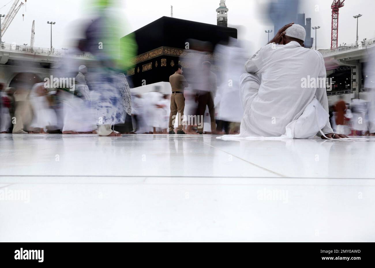 A Saudi security guard stands as Muslim pilgrims circle the Kaaba ...