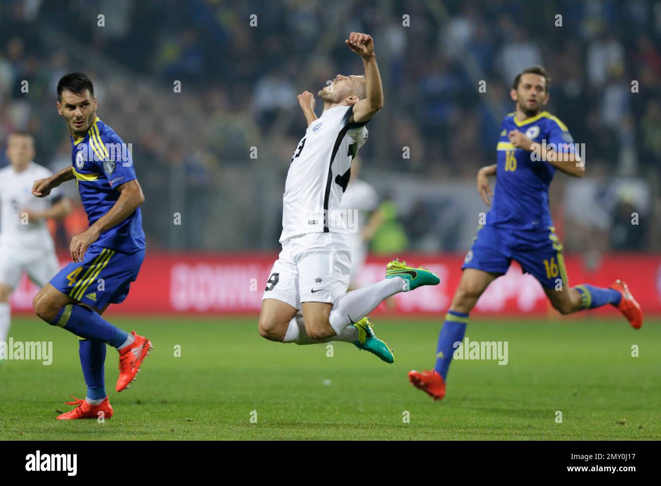 Bosnia's Emir Spahic, left, and Edin Visca , right, challenges Estonia ...