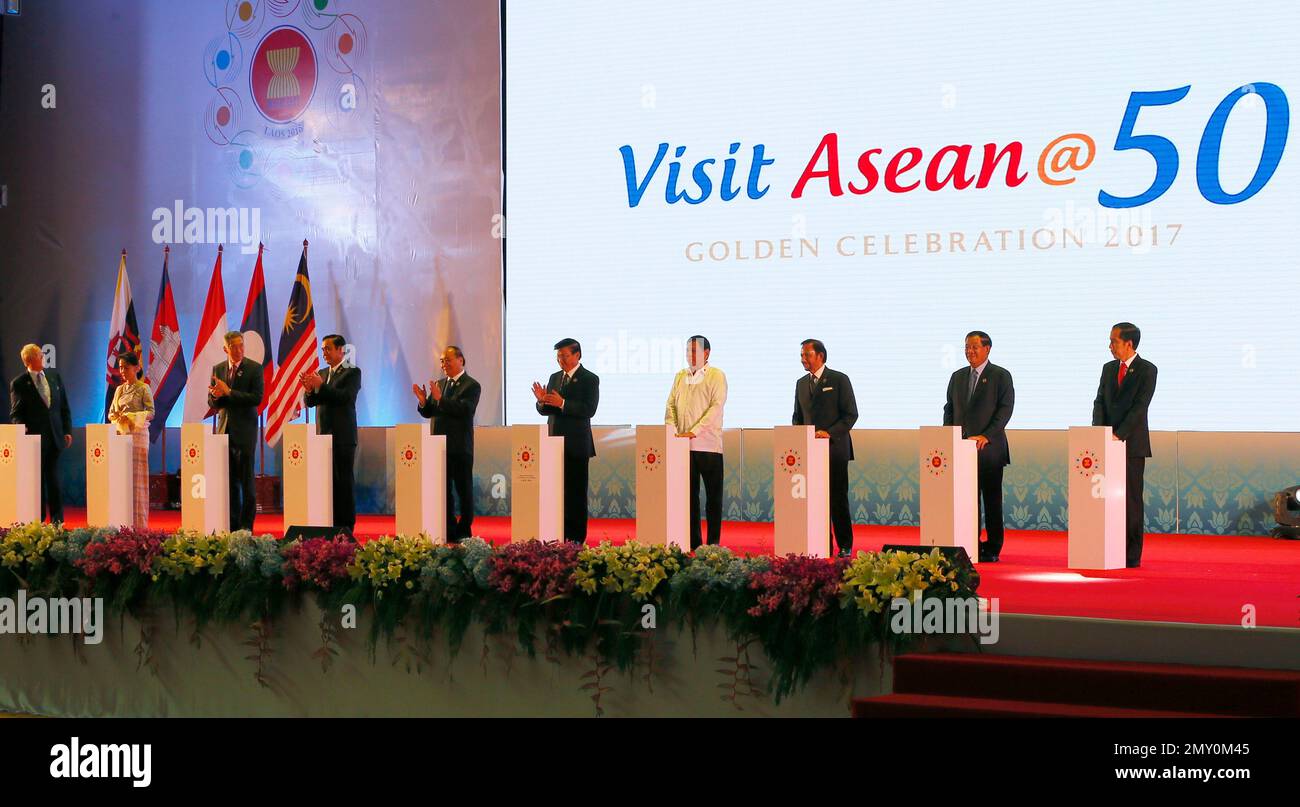 ASEAN leaders applaud following the ceremonial switching of the "Visit ...