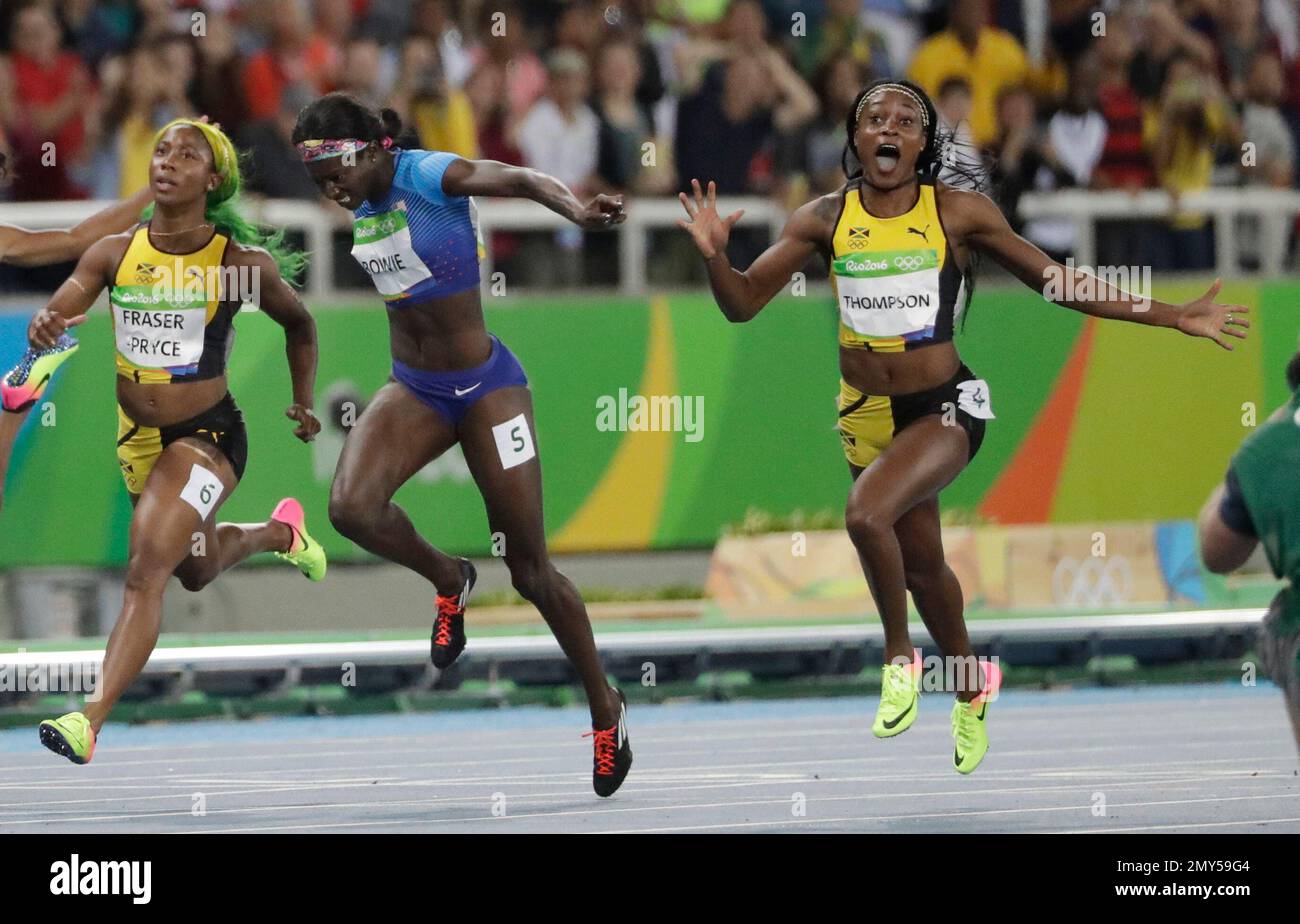 Jamaica's Elaine Thompson, right, wins the gold medal in the women's 100-meter final ahead of ...