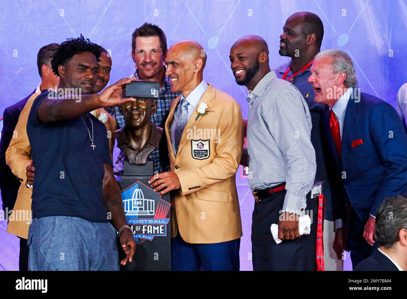 Former NFL coach and player Tony Dungy, center, takes a selfie with ...