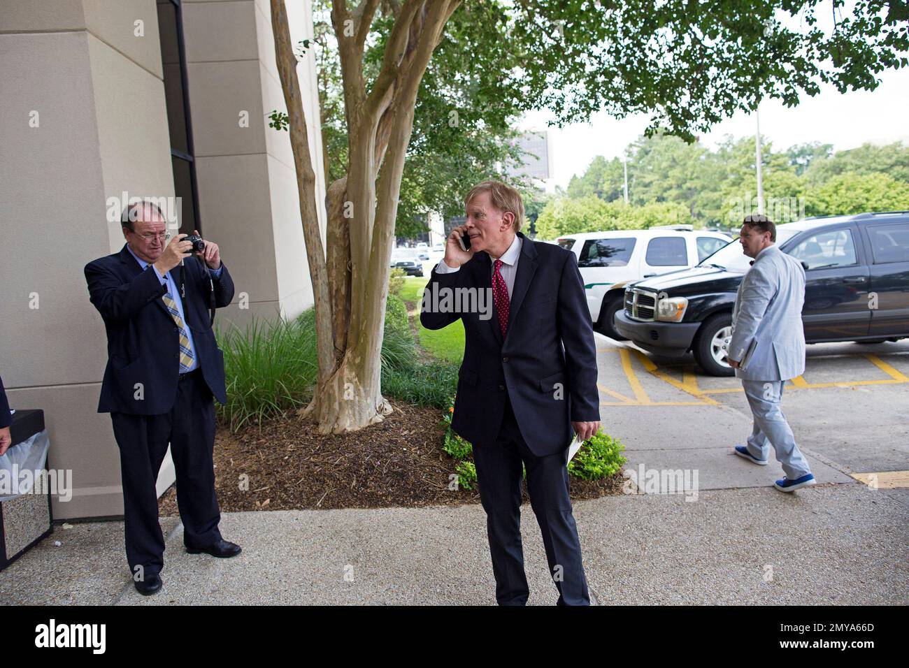 Former Ku Klux Klan leader David Duke talks on the phone after arriving ...