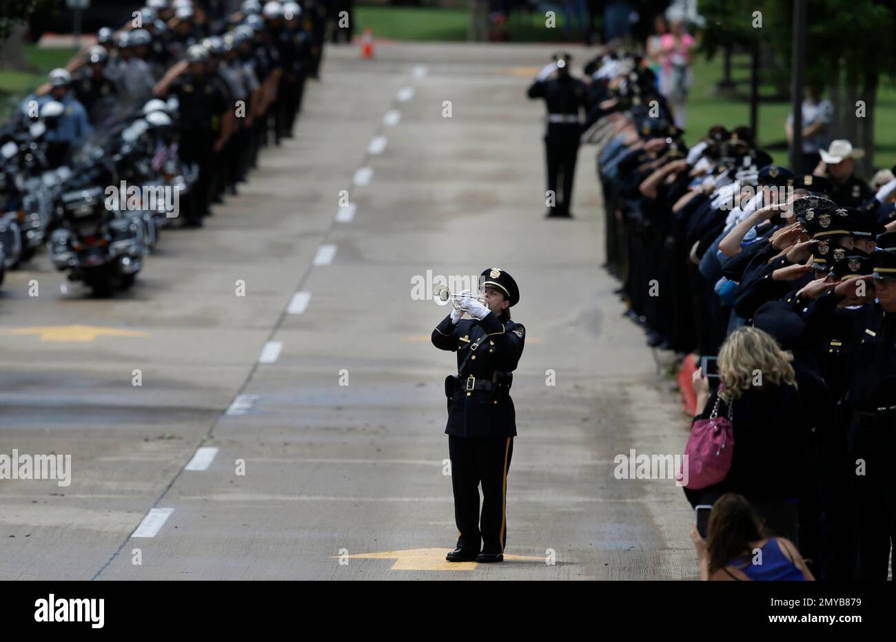 "Taps" is played during a honor guard presentation for slain Dallas ...