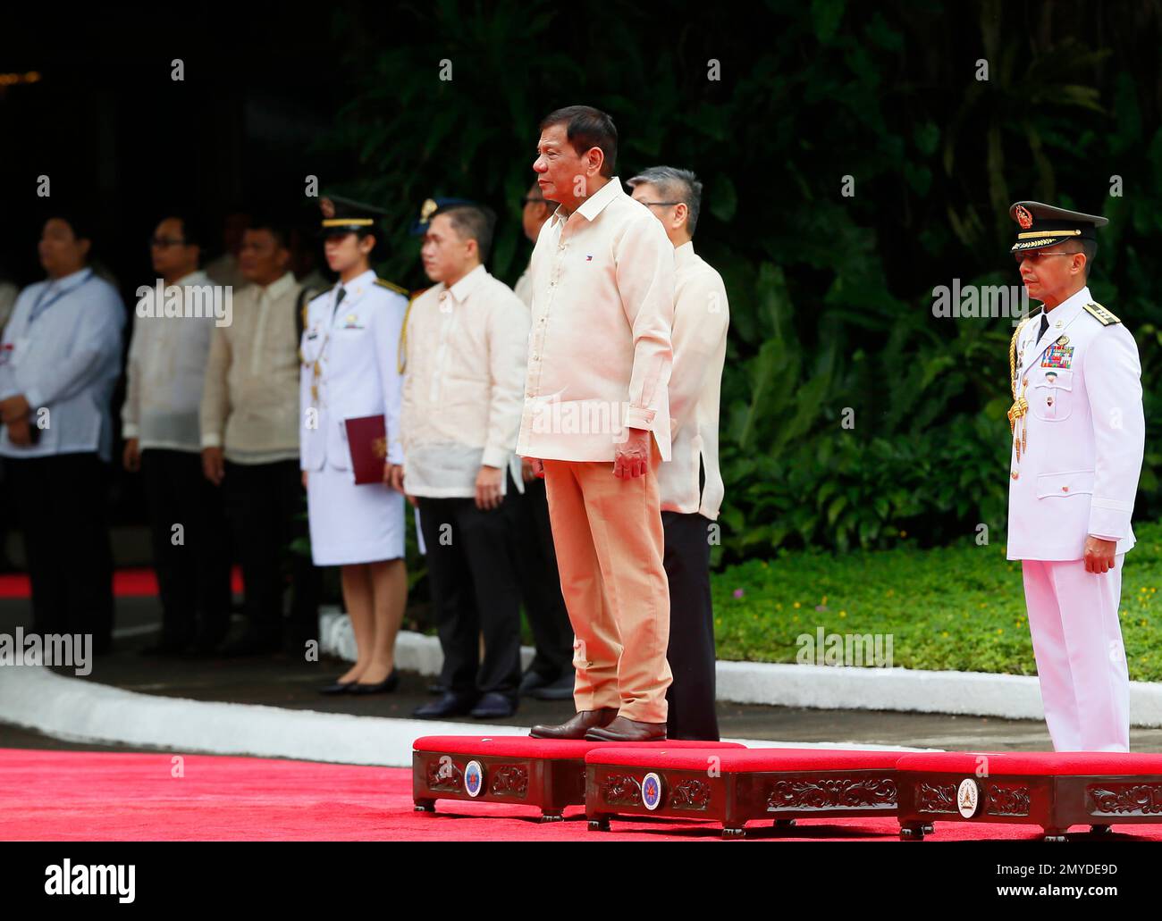 New Philippine President Rodrigo Duterte stands on the dais as outgoing ...