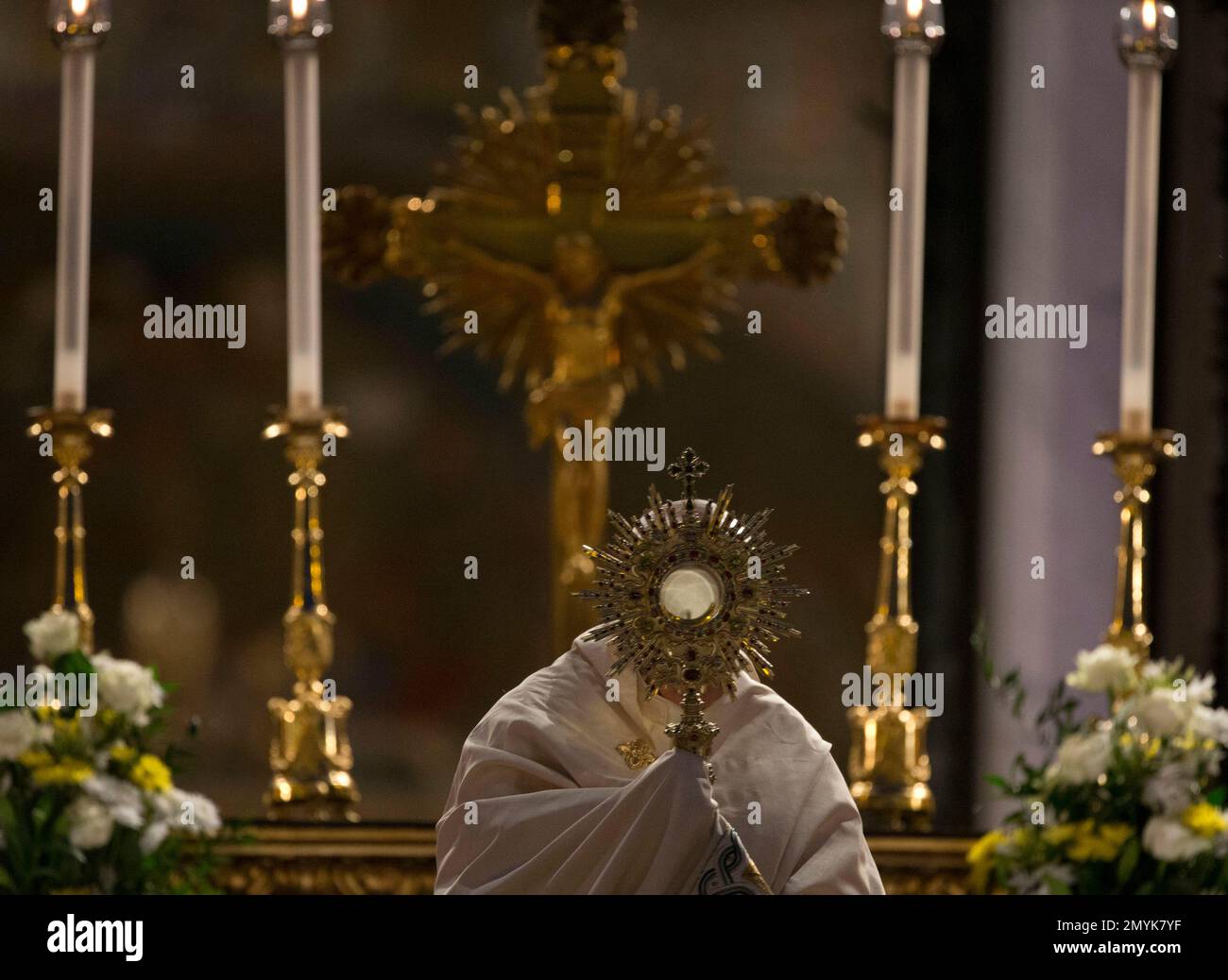 Pope Francis holds a monstrance containing a Holy Host at the end of ...