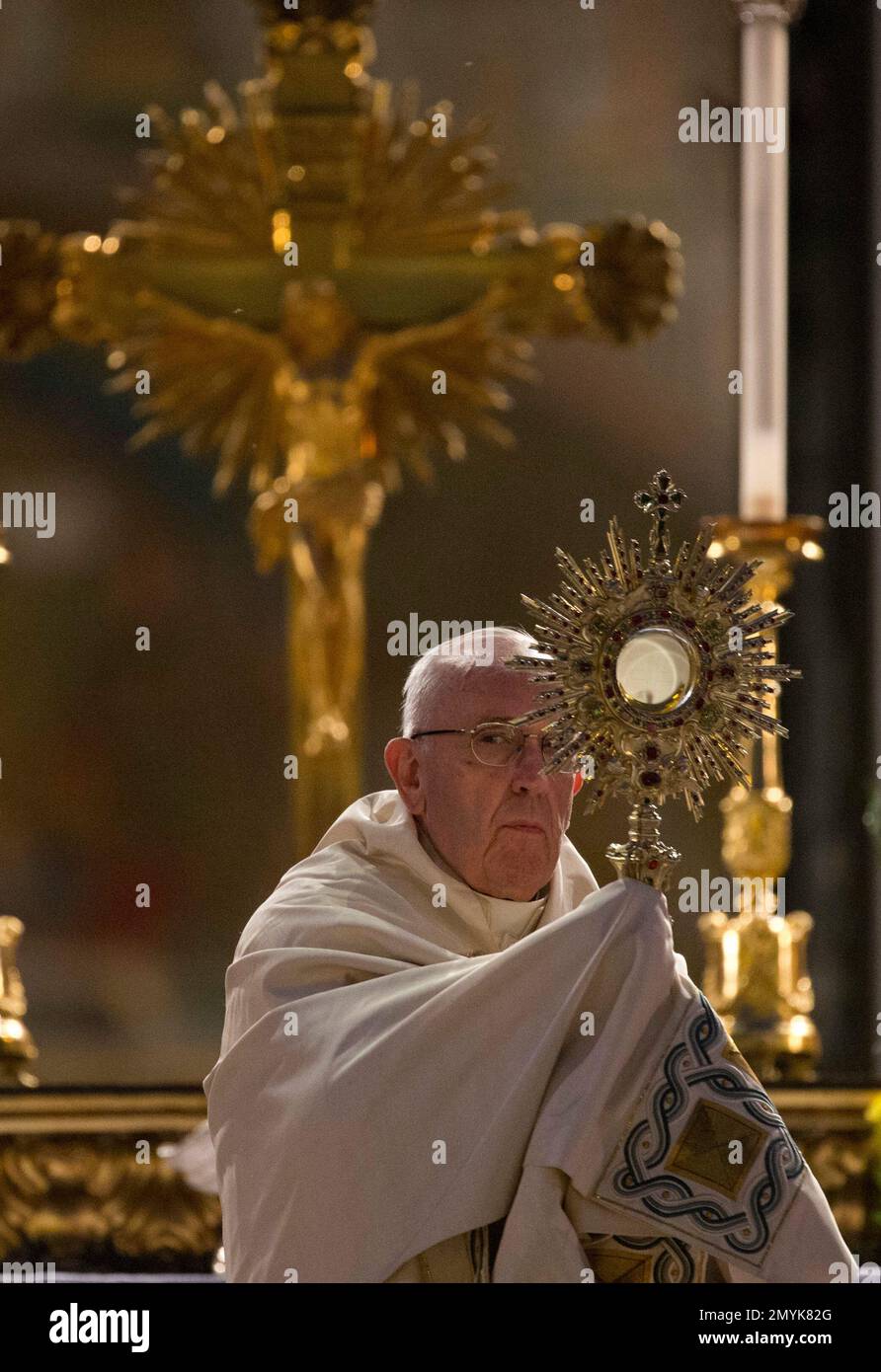 Pope Francis holds a monstrance containing a Holy Host at the end of ...