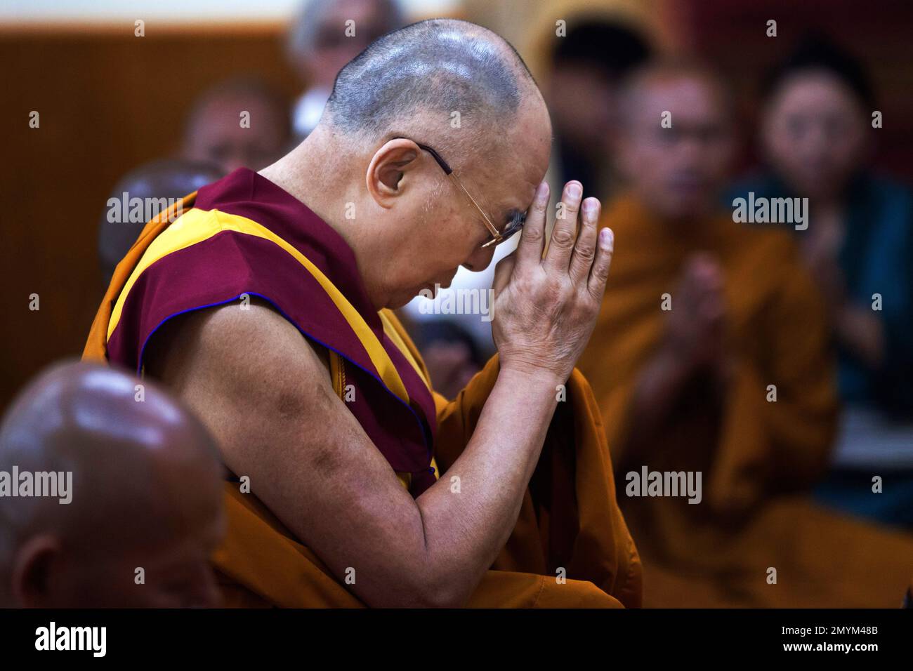 Tibetan spiritual leader the Dalai Lama prays with a group of Thai ...
