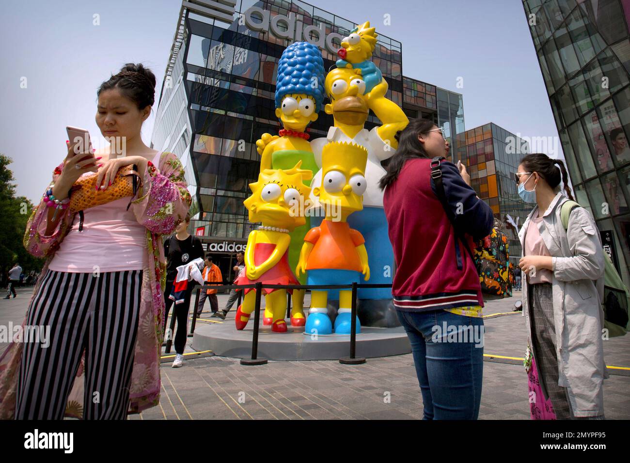 Visitors stand near statues of characters from the cartoon series "The ...