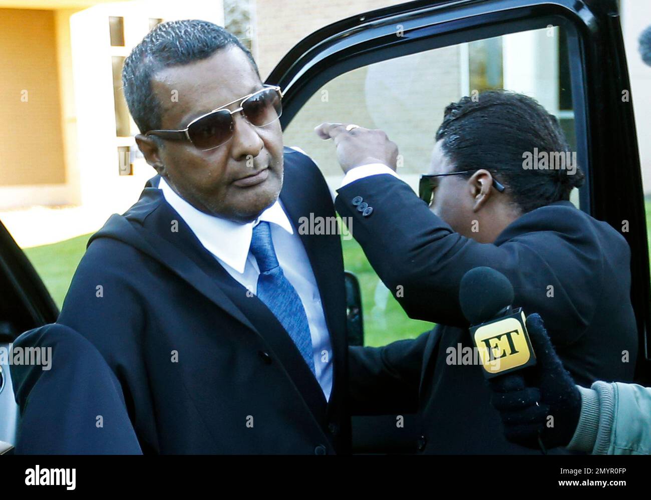 Alfred Jackson, left, the half-brother of Prince, is helped with his ...