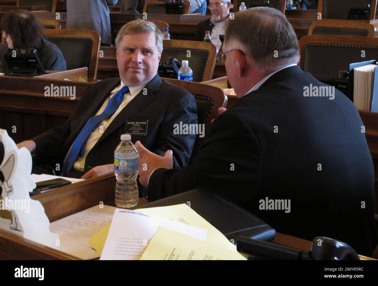 Kansas state Rep. Mark Hutton, left, R-Wichita, confers with Rep. Dan ...
