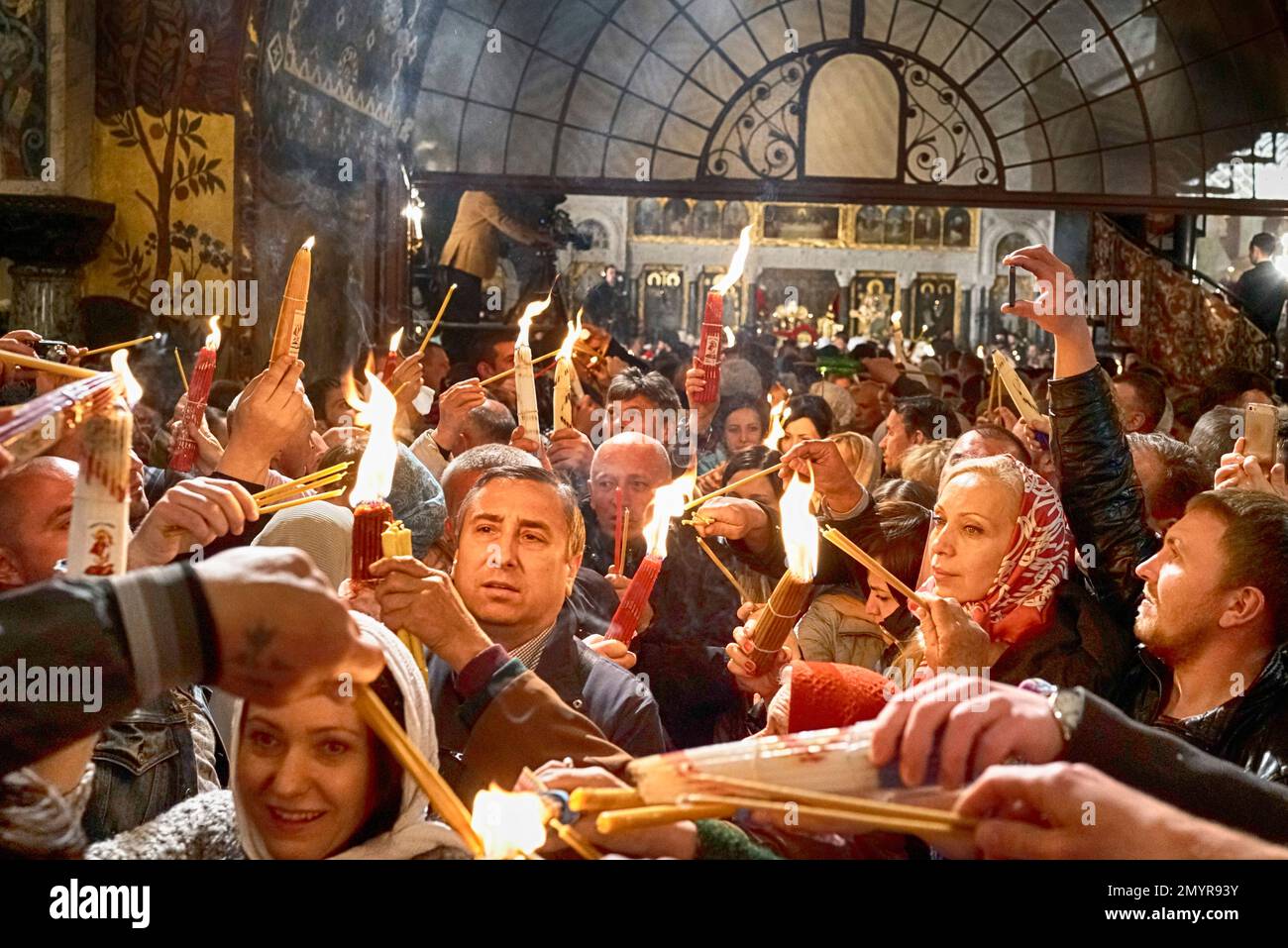 Ukrainian Orthodox faithful light candles from the Holy Fire brought ...