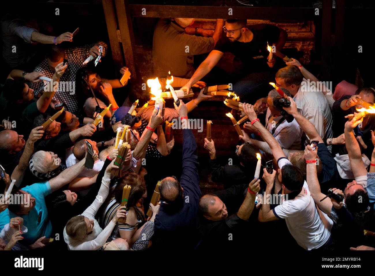 Christian Orthodox pilgrims hold candles during the Holy Fire ceremony ...