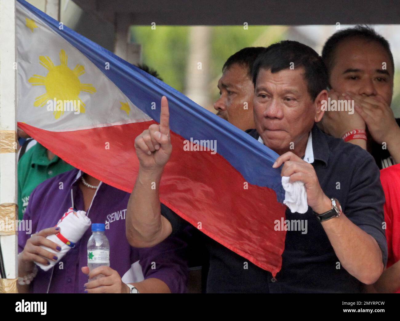 Presidential candidate Mayor Rodrigo Duterte holds a Philippine flag ...