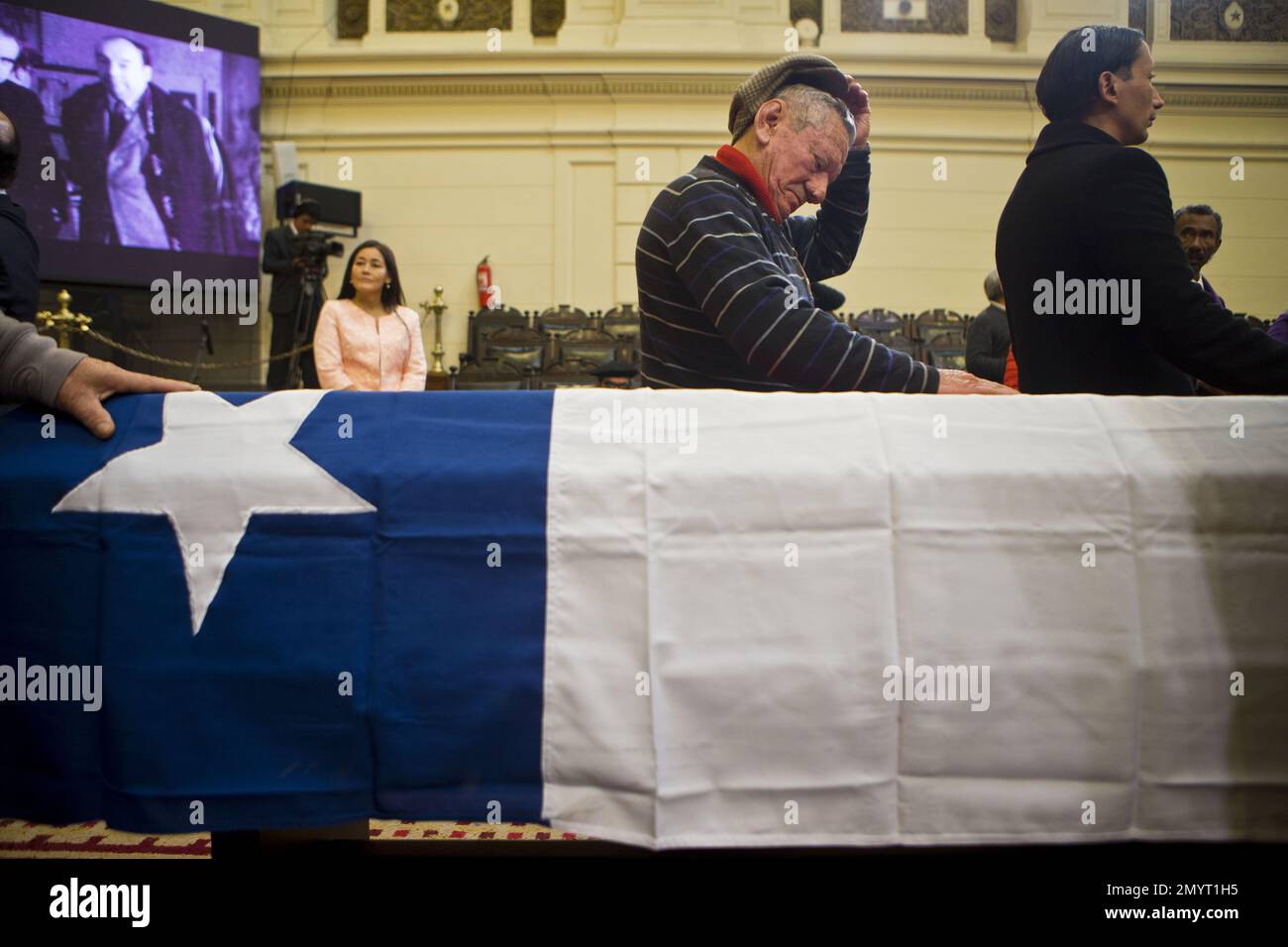 People file past the flag-draped coffin containing the remains of the ...