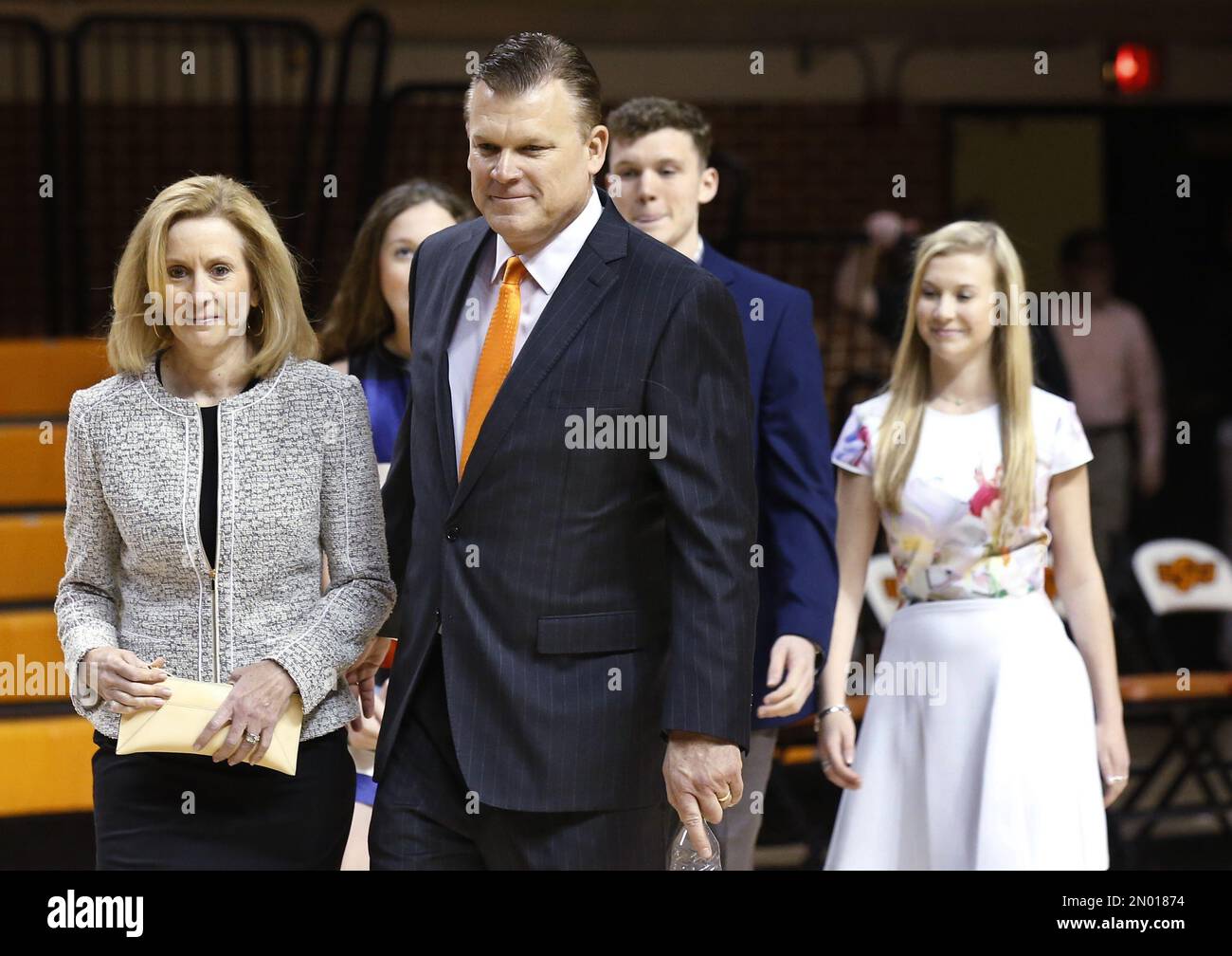 Brad Underwood, center, arrives at a news conference with his wife ...