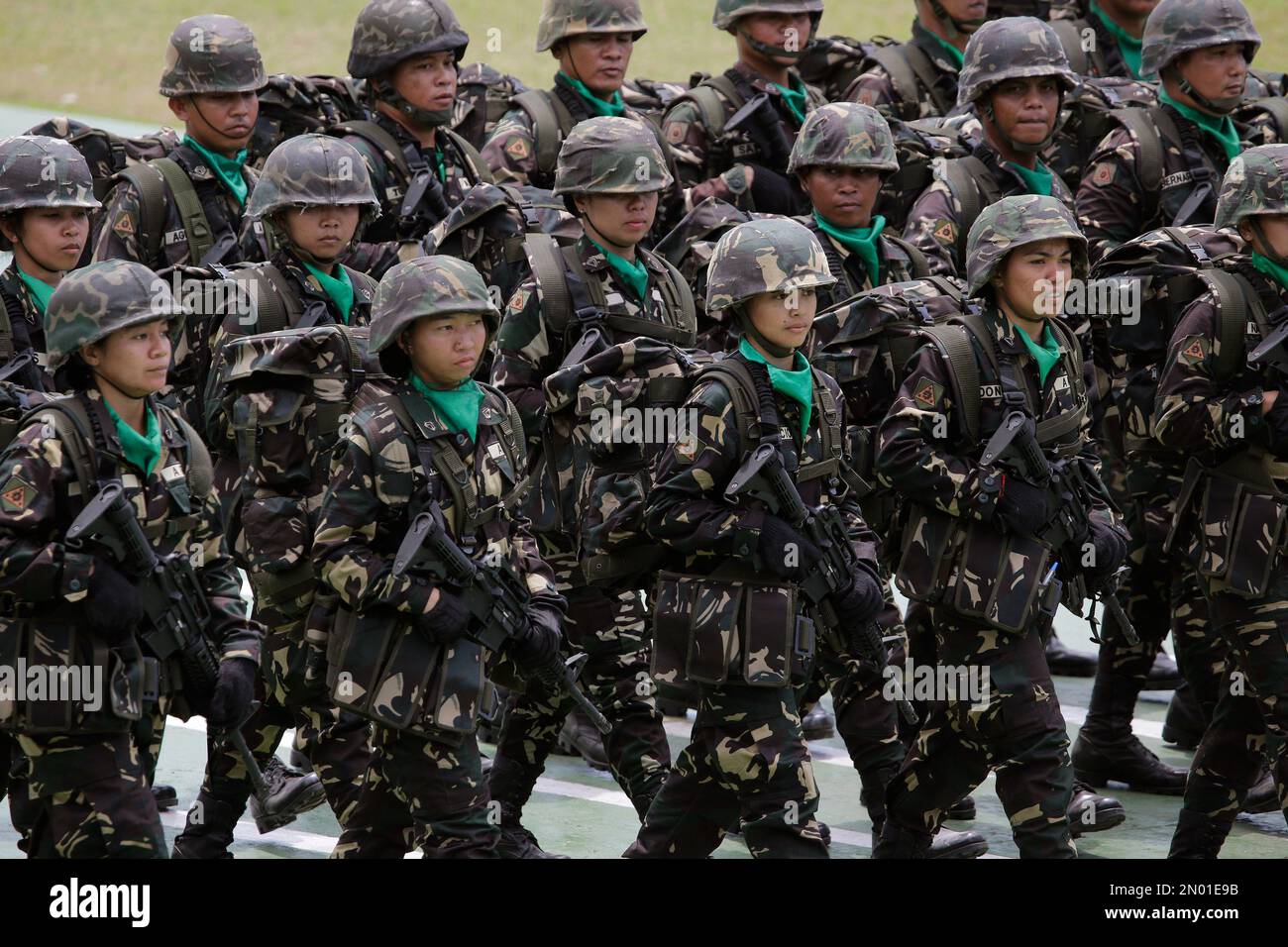 Filipino women troopers march during ceremonies for the 119th founding ...