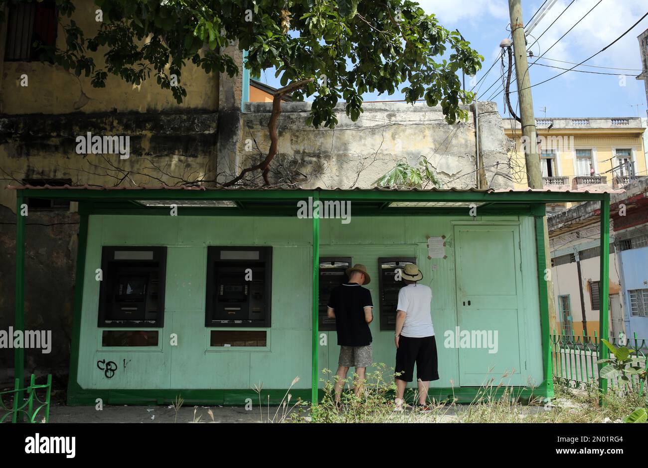 Foreign tourists use an ATM machine in downtown Havana, Cuba, Sunday ...