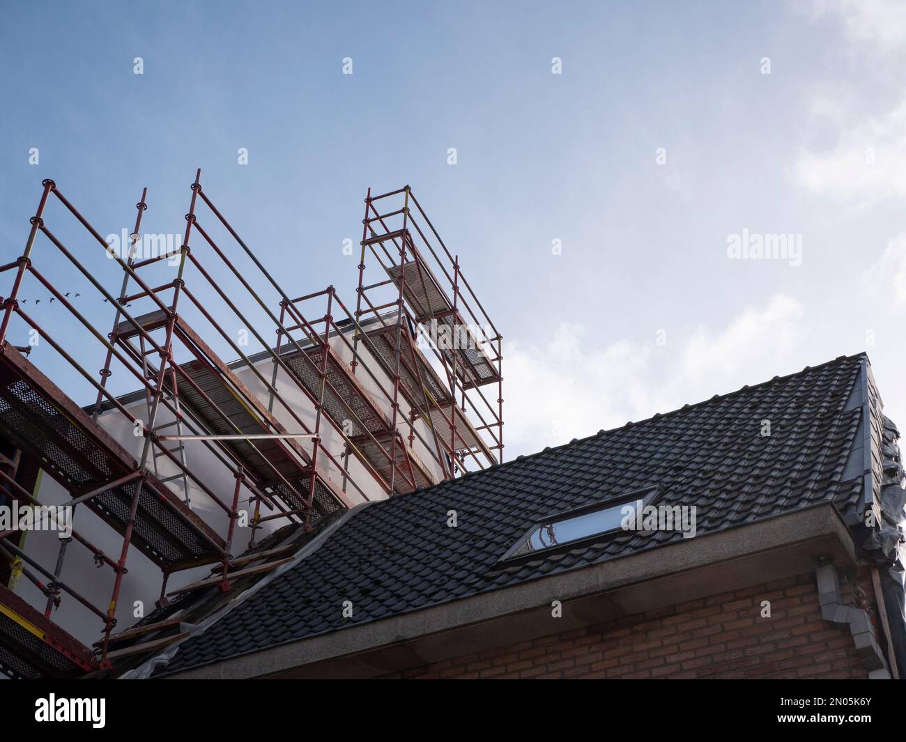 Échafaudage sur et à côté du toit d'une maison adjacente pour pouvoir ...