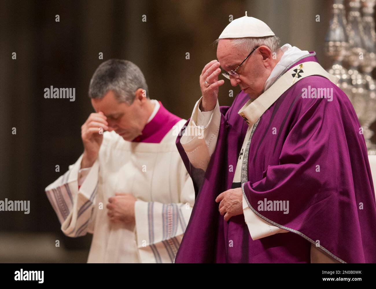 Pope Francis crosses himself as he leads the Ash Wednesday mass, in St ...