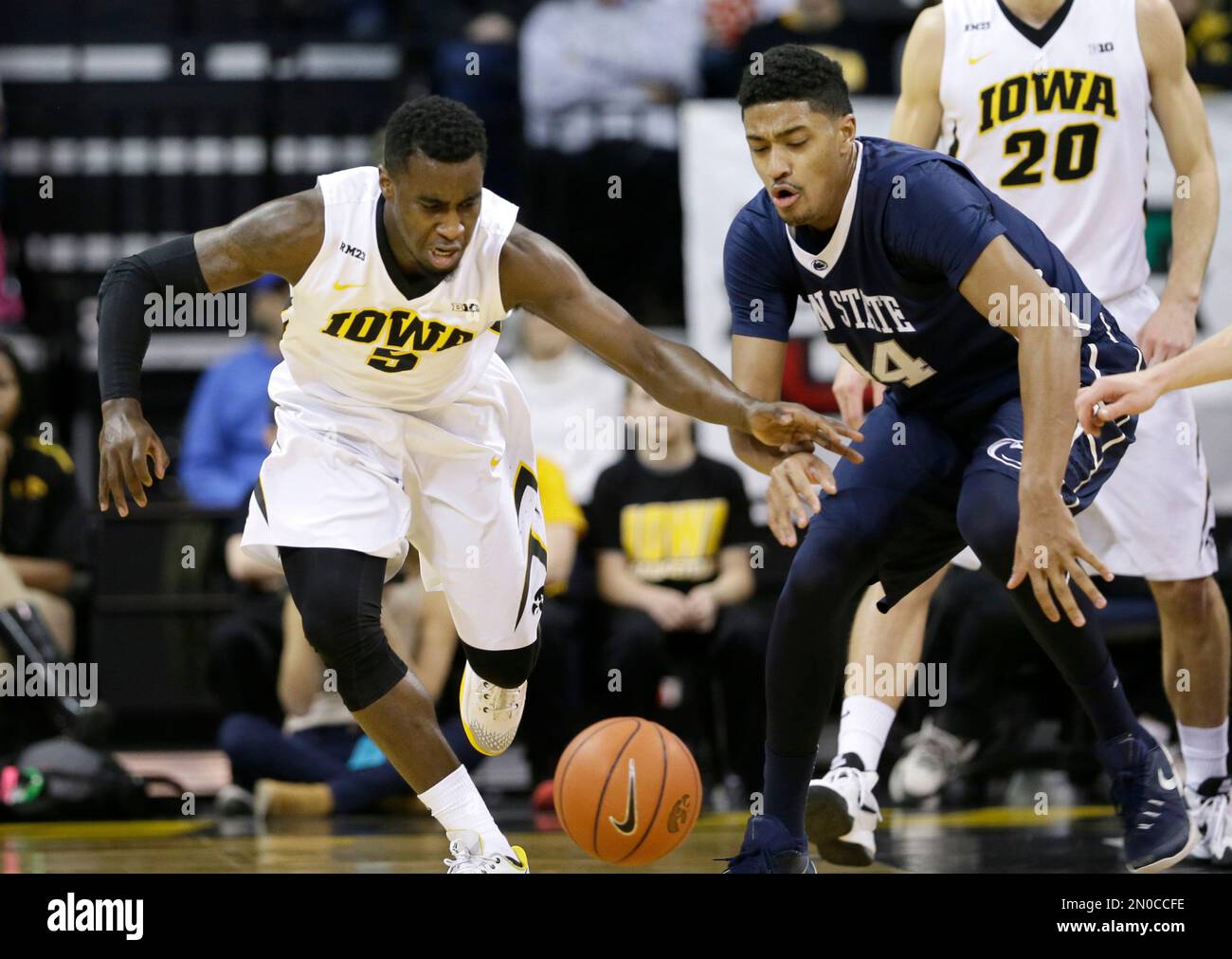 Iowa guard Anthony Clemmons, left, fights for a loose ball with Penn ...