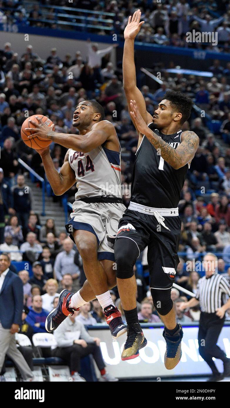 Connecticut's Rodney Purvis (44) drives past Cincinnati's Jacob Evans ...