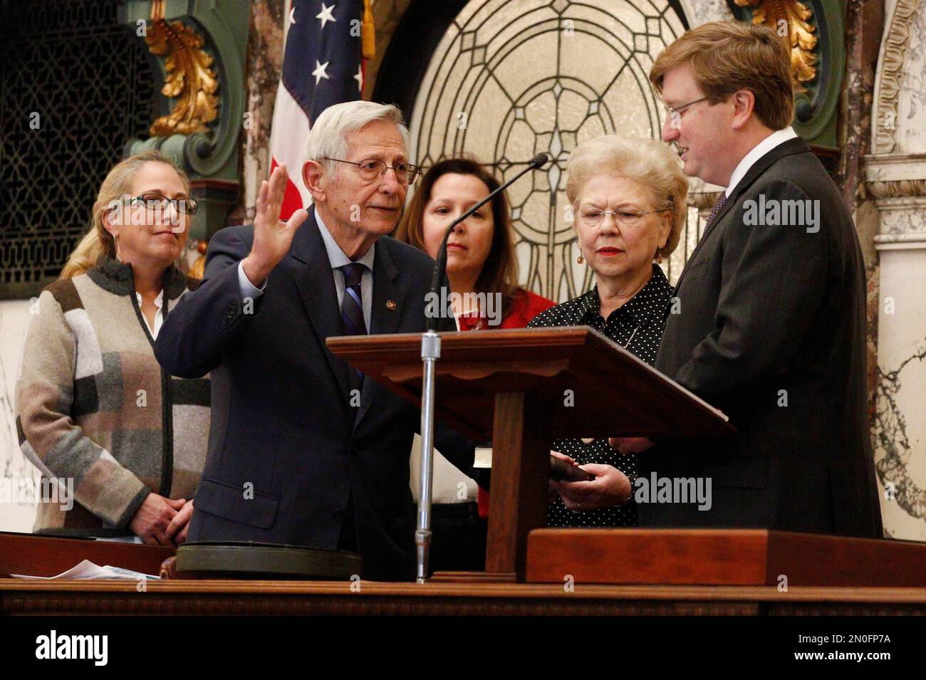 Democrat Bob Dearing, front left, raises his right hand as his ...