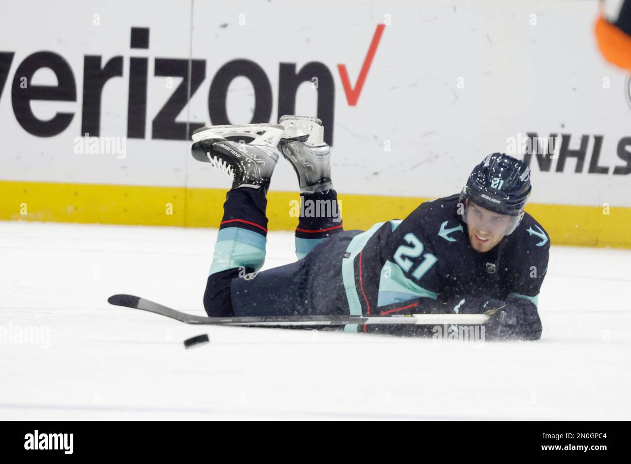 Seattle Kraken center Alex Wennberg (21) hits the puck lying on the ice ...