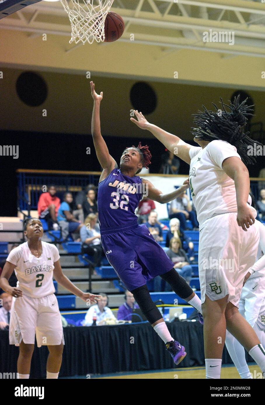 James Madison guard Angela Mickens (32) goes up for a shot between ...