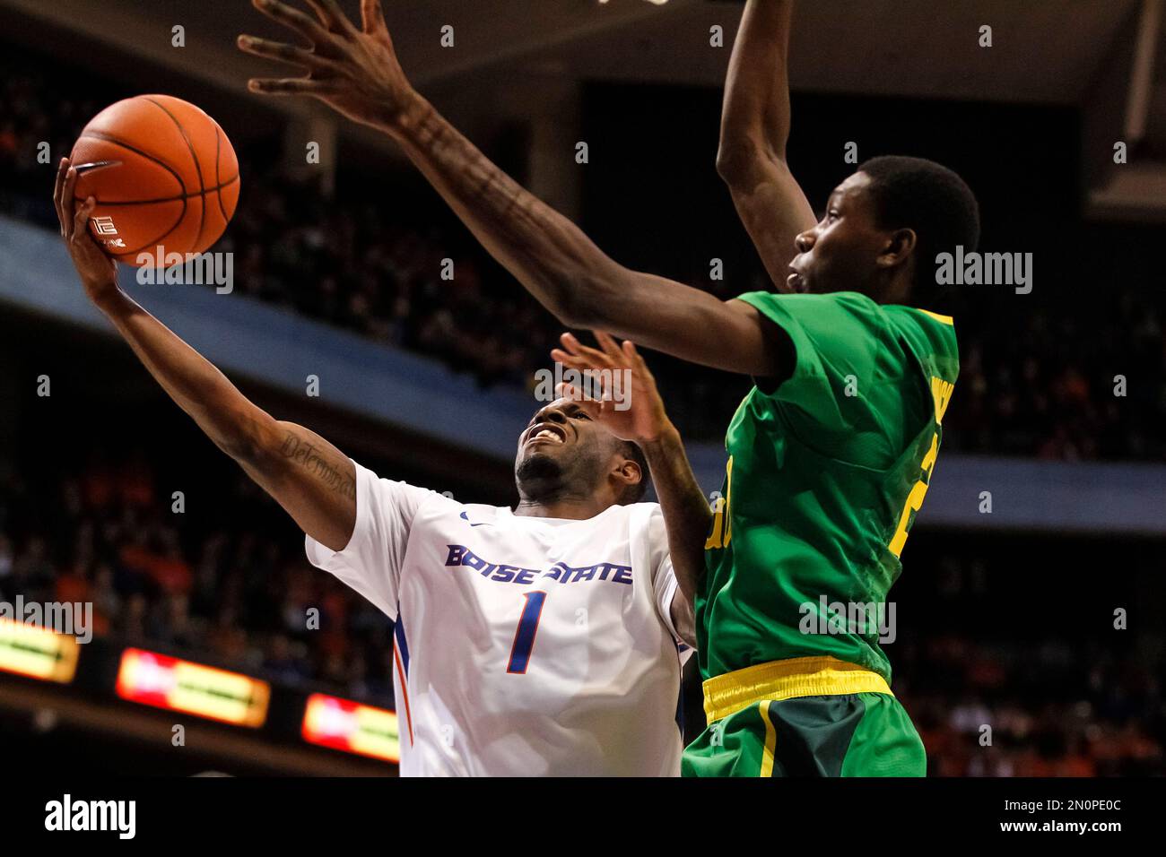 Boise State's Mikey Thompson (1) shoots past Oregon's Chris Boucher ...