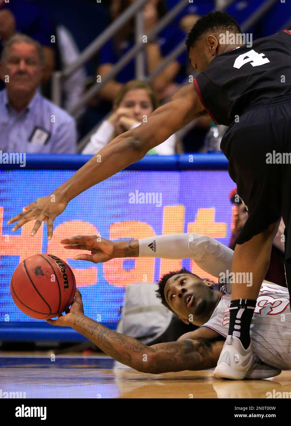 Kansas forward Jamari Traylor (31) passes to a teammate while covered ...