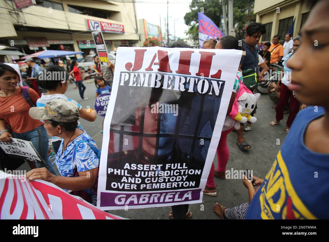 A protester holds a slogan with a picture of U.S. Marine Lance Cpl ...