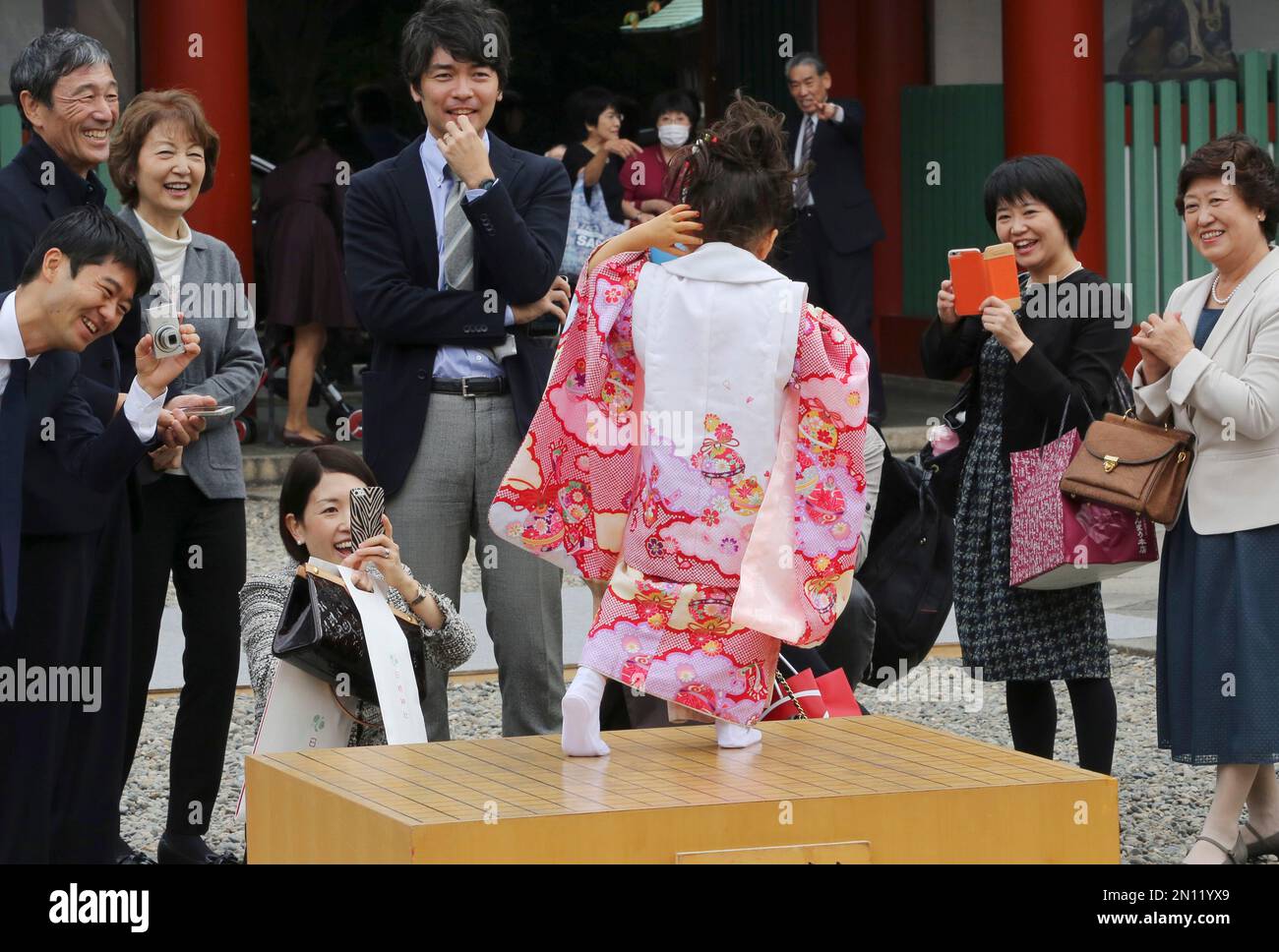 A kimono-clad girl poses for a photo during an annual festival at Hie ...