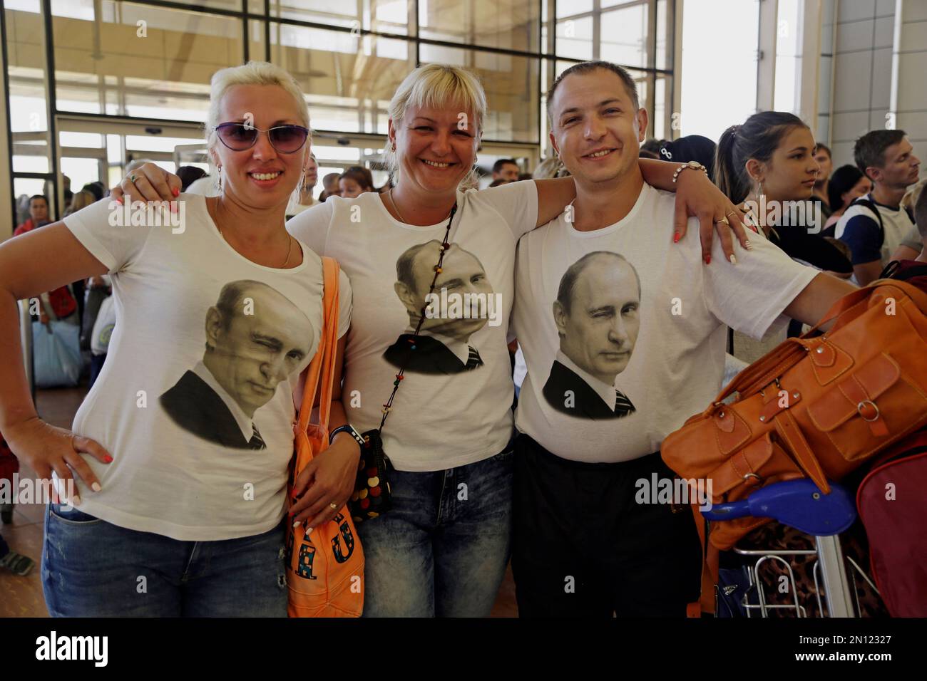 Russian tourists wearing t-shirts with images of Russian President ...