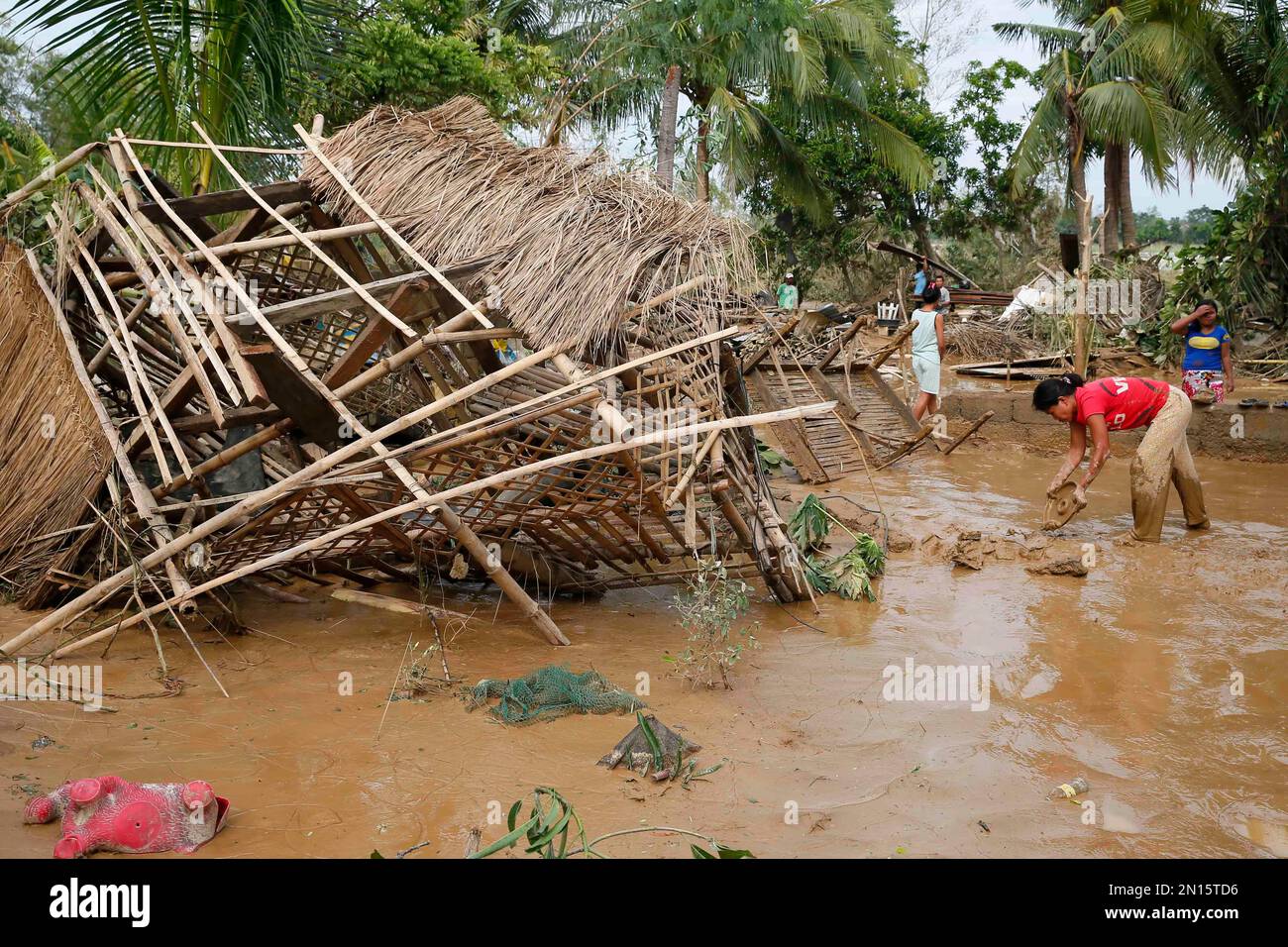 Residents begin cleaning up their homes in Cabanatuan, Philippines ...