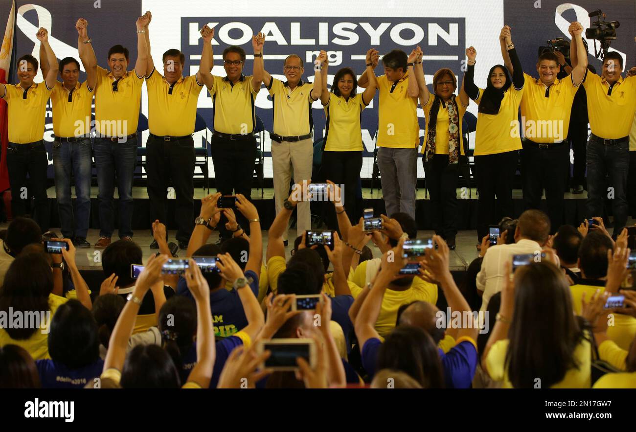 Philippine President Benigno Aquino III, 6th from left, raises hands ...