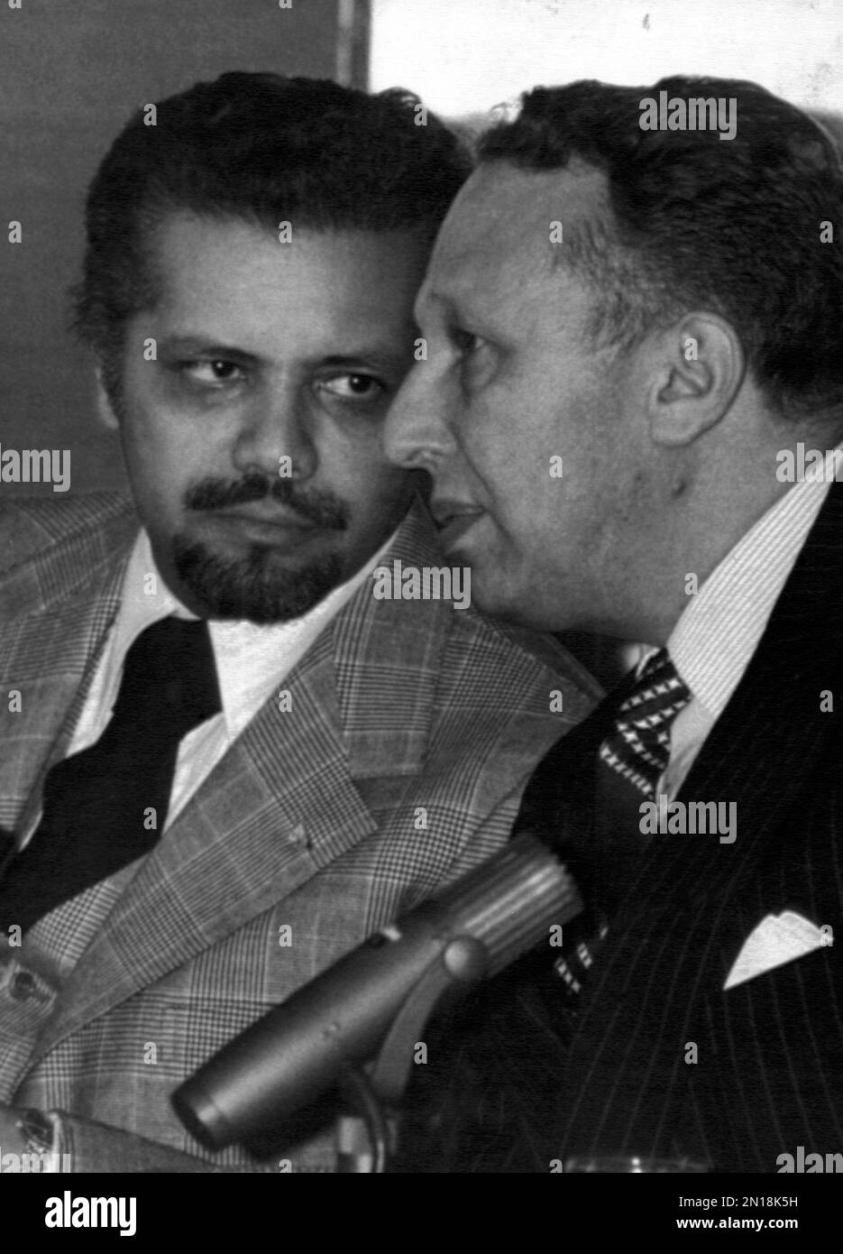 Saudi Arabian Oil Minister Sheikh Ahmed Zaki Yamani, left, leans toward ...