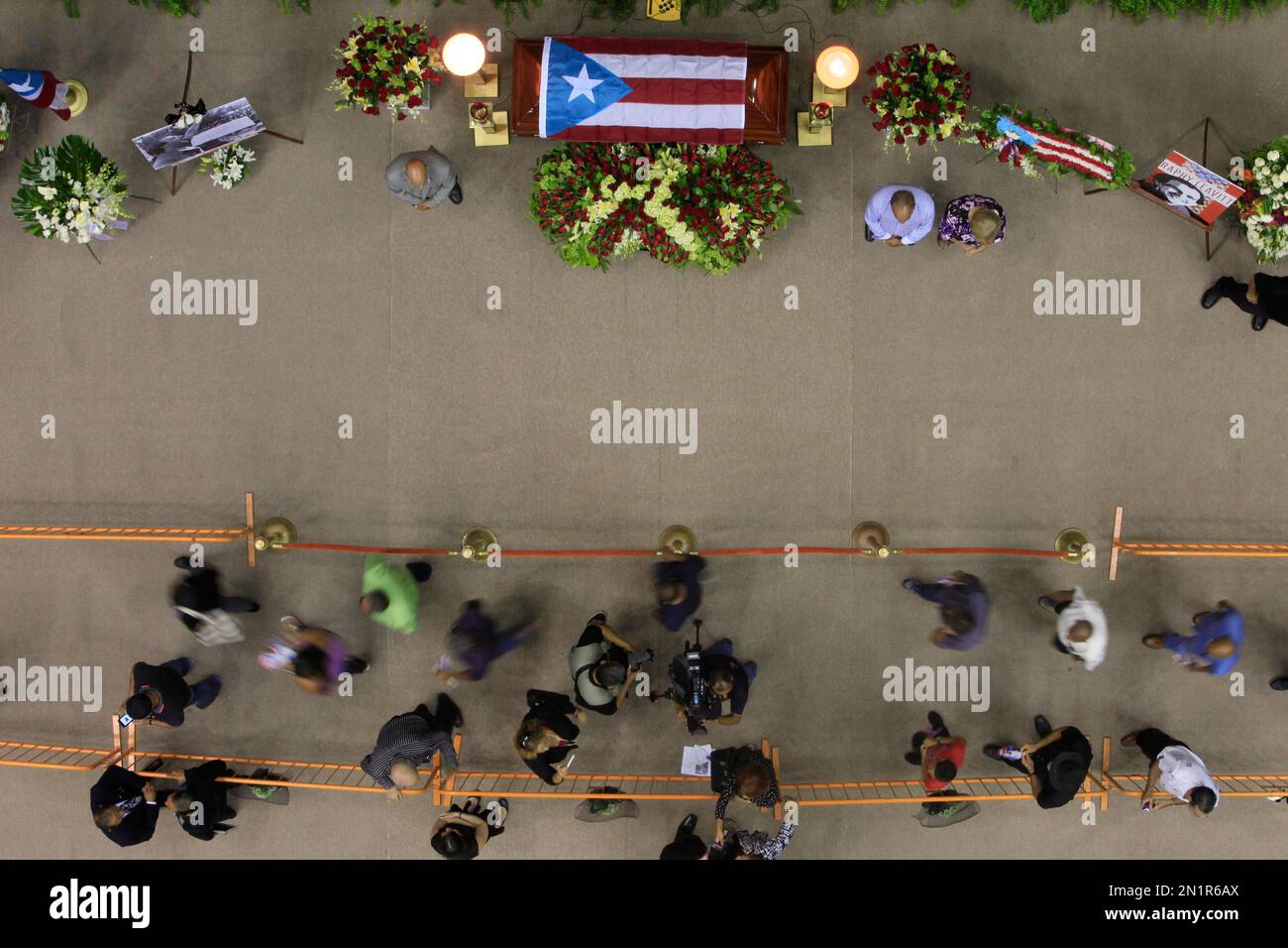 Mourners file past the casket containing the remains of Puerto Rican ...