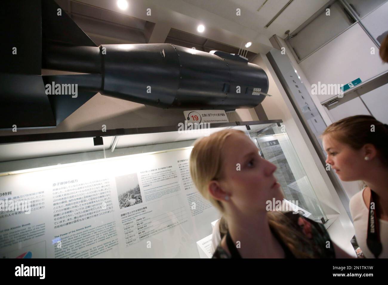 Students from Sweden look at a scale model of atomic bomb displayed at ...