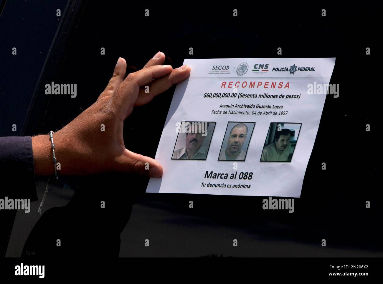 A Federal Police presses on a reward notice for information leading to ...