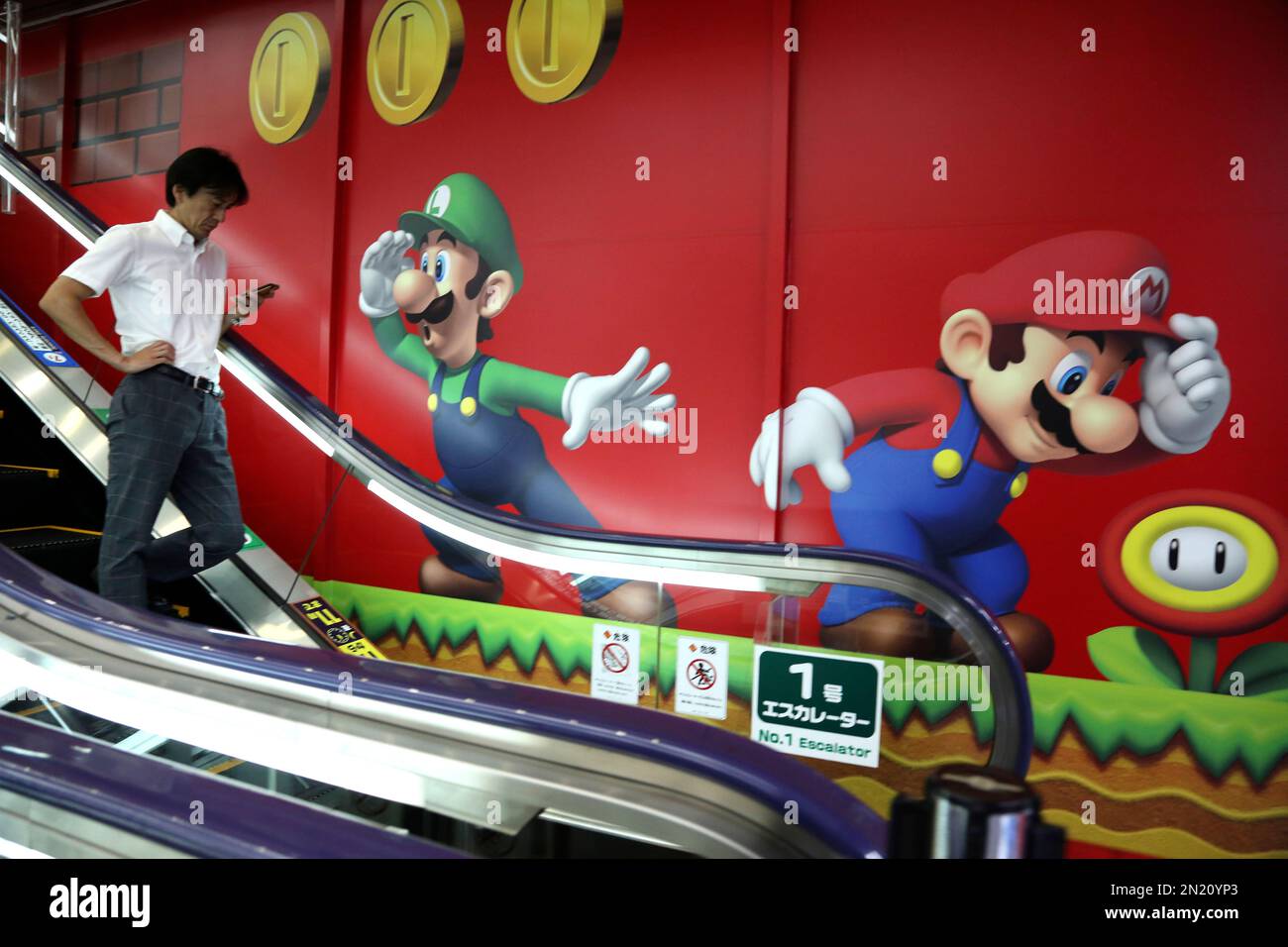 A shopper walks in front of Nintendo's Super Mario characters at an ...